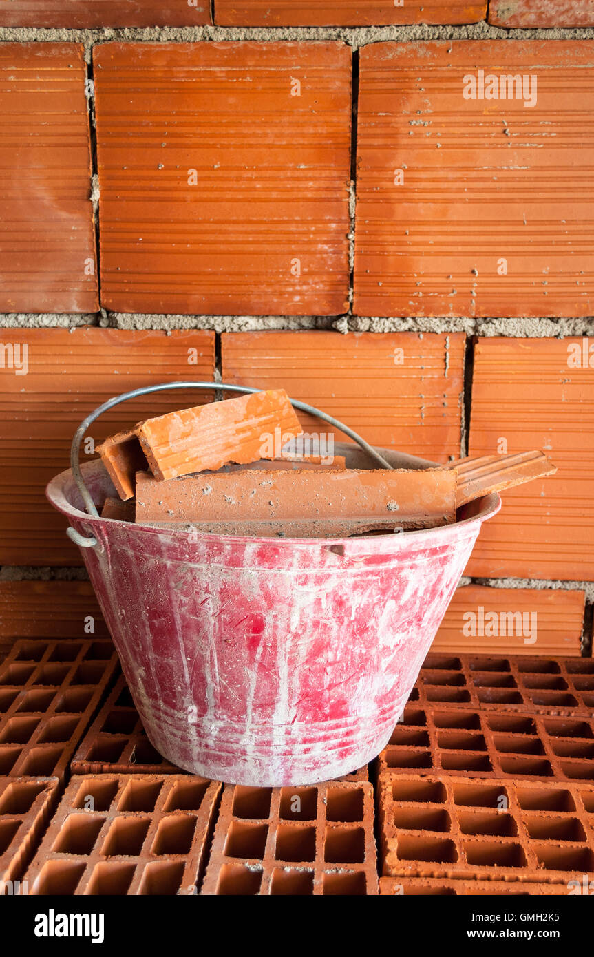 Masonry Bucket on hollow bricks Stock Photo - Alamy
