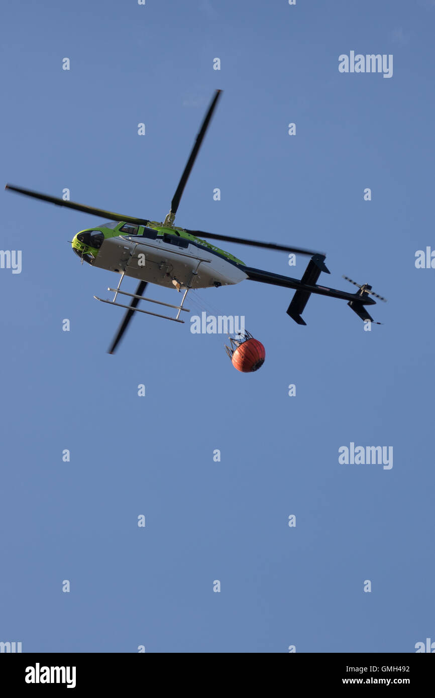 Water dropping firefighting helicopters in flight Stock Photo - Alamy