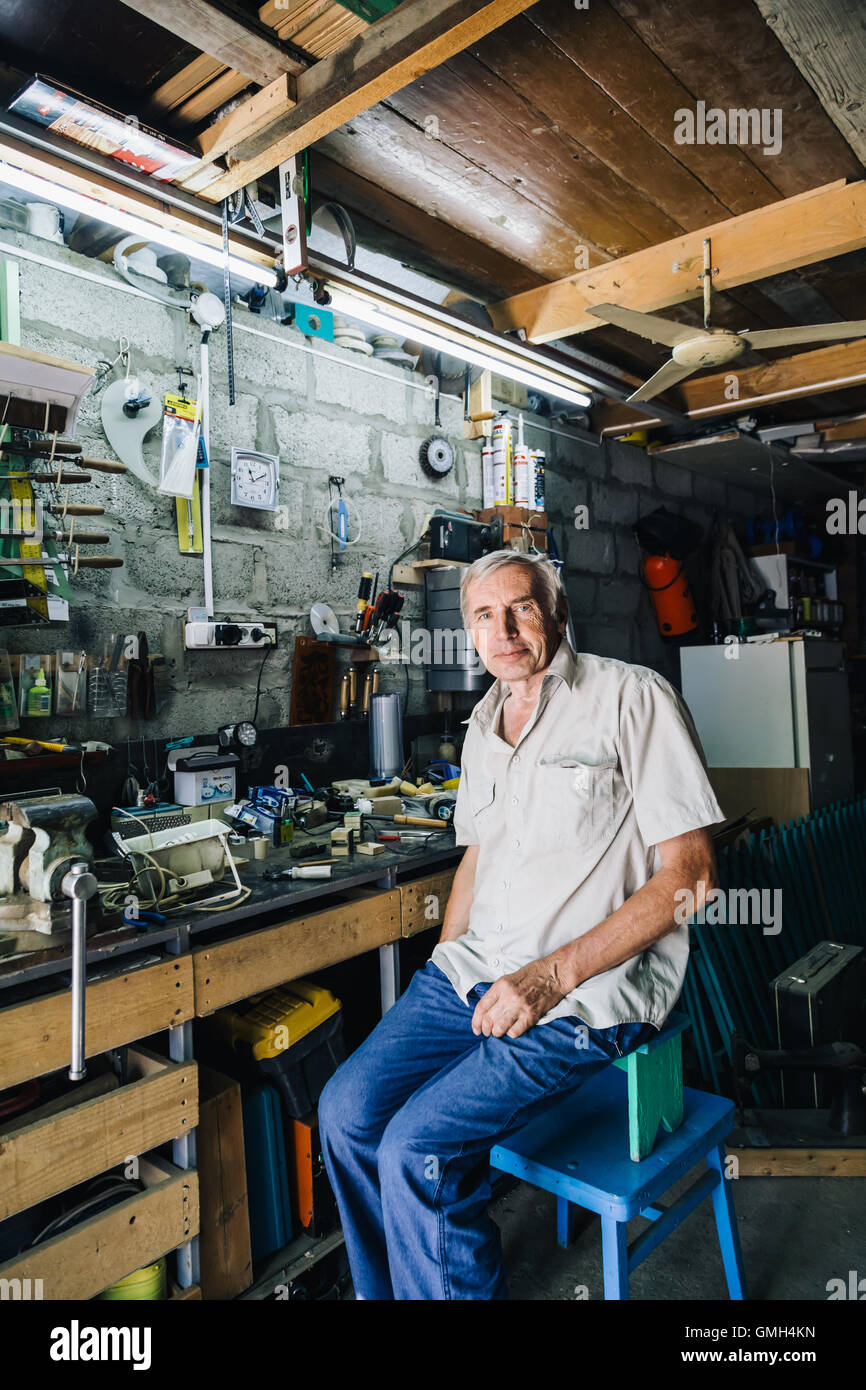 Senior mechanic working in garage Stock Photo - Alamy
