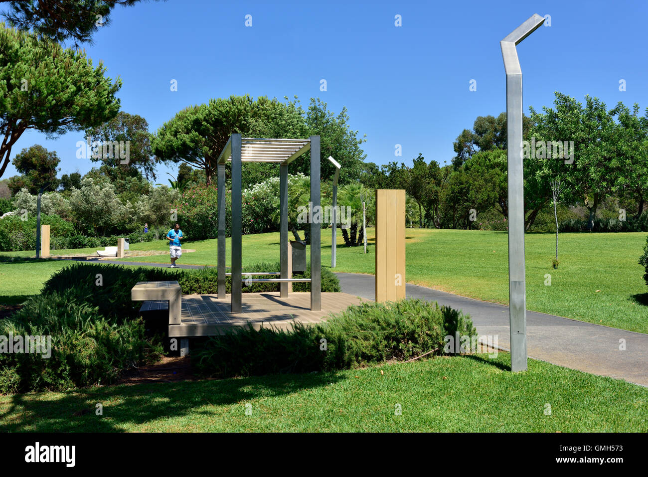 Park with cycle path, walkway and exercise stations in the middle of ...