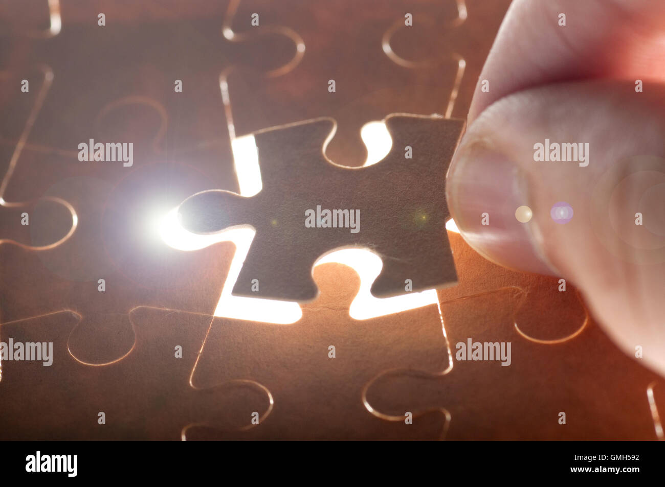 hand holding puzzle piece close up Stock Photo - Alamy