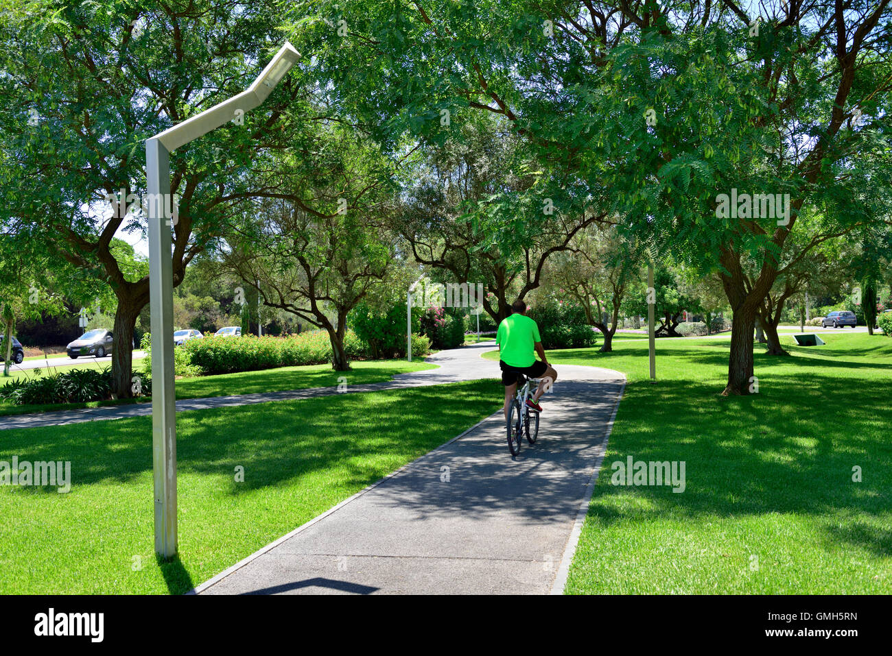 Park with cycle path, walkway and exercise stations in the middle of ...