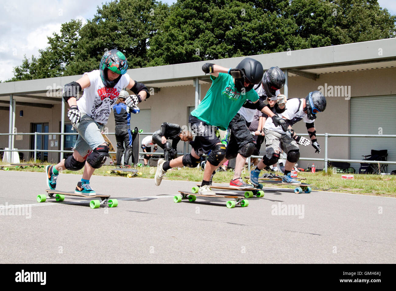 Skateboarders start a downhill race Stock Photo - Alamy