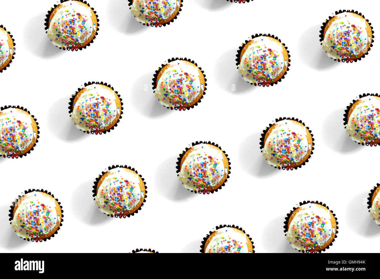 A large grid of cupcakes with icing and hundreds and thousands ...