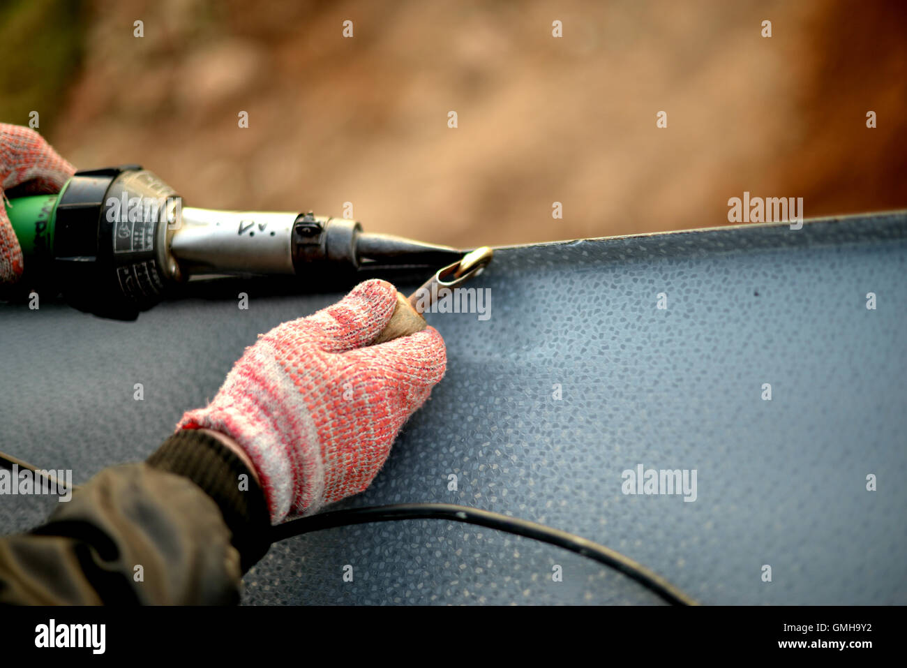 Guy melting PVC coating for roof Stock Photo - Alamy