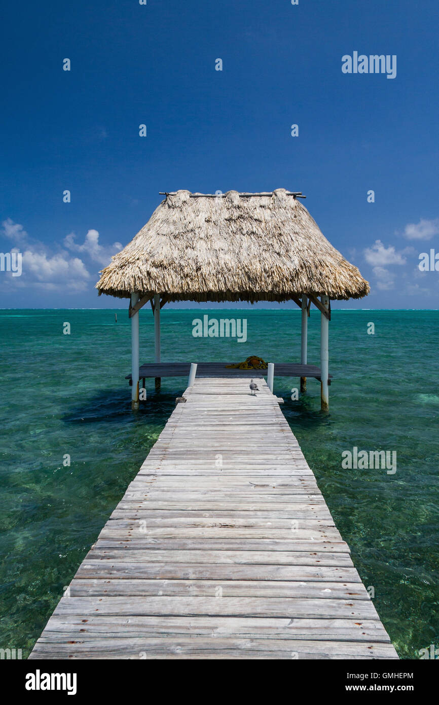 A palapa awaits visitors at the end of a short pier in Caye Caulker ...