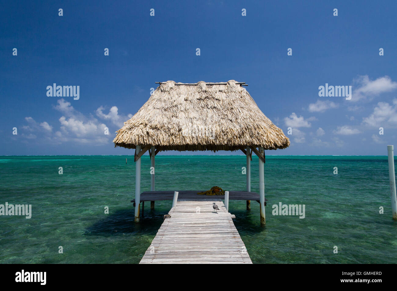 A palapa awaits visitors at the end of a short pier in Caye Caulker ...