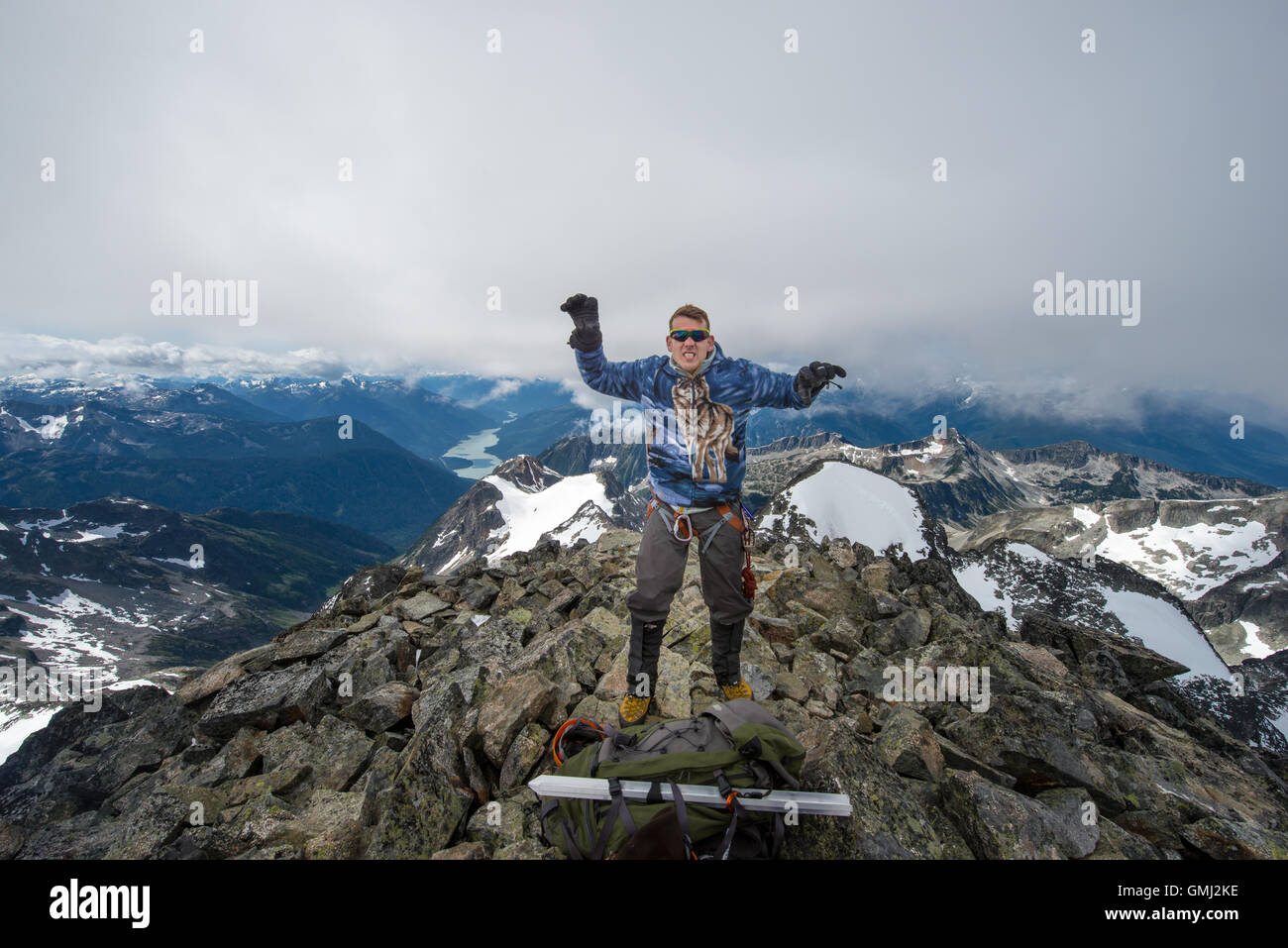 A mountain climber on top of a summit Stock Photo - Alamy