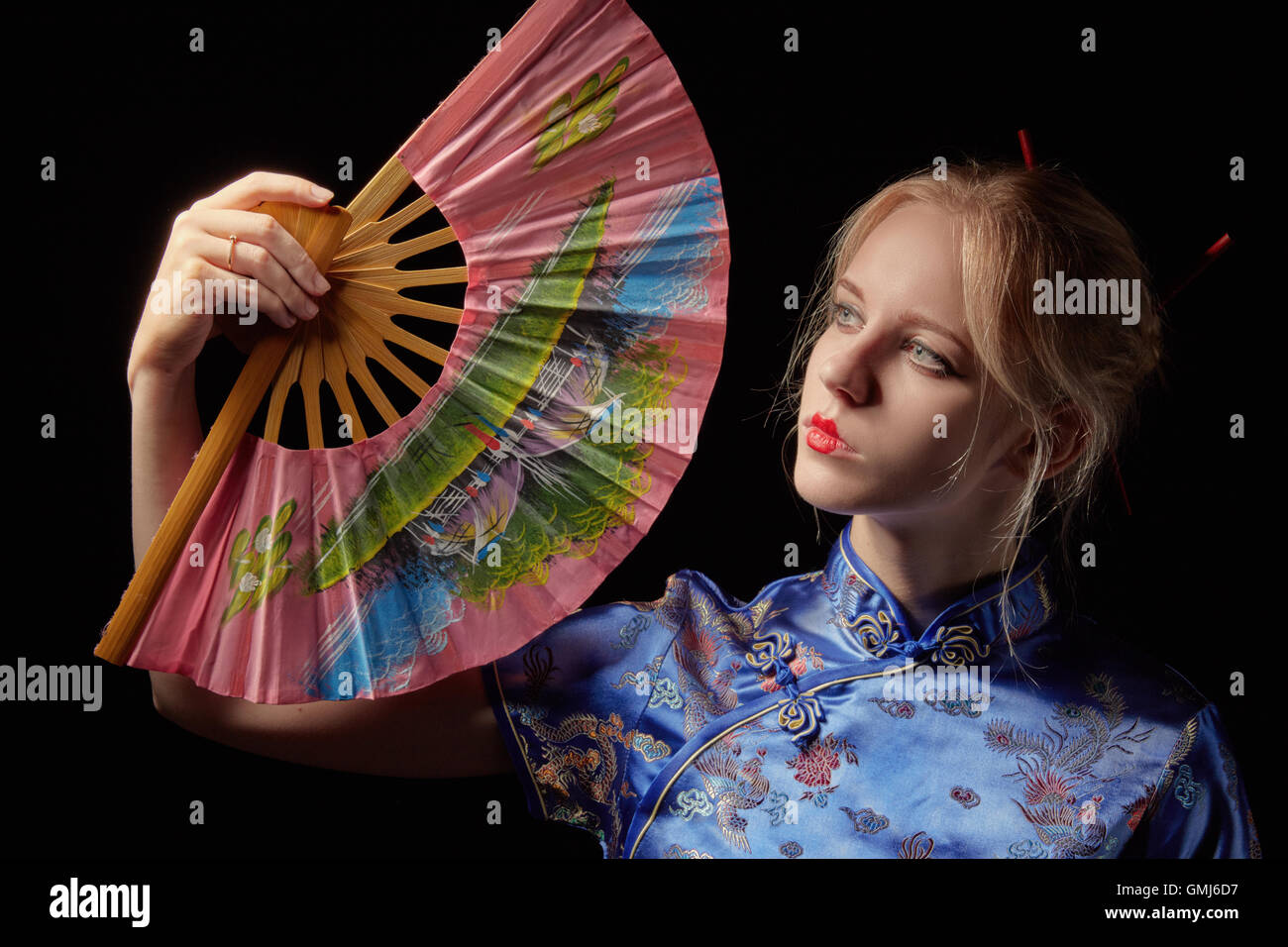 girl in japanese dress with fan on black background Stock Photo - Alamy