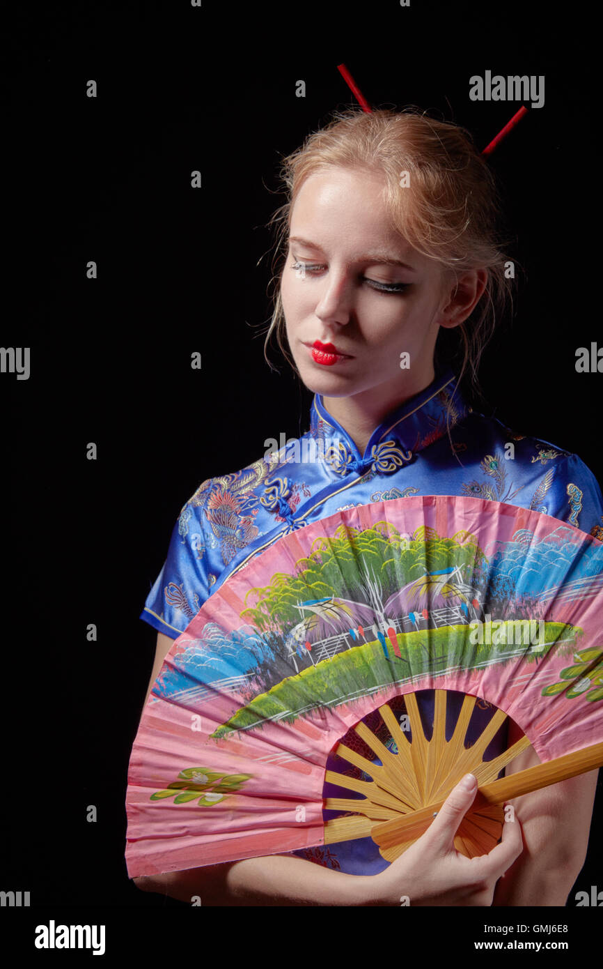 girl in japanese dress with fan on black background Stock Photo - Alamy