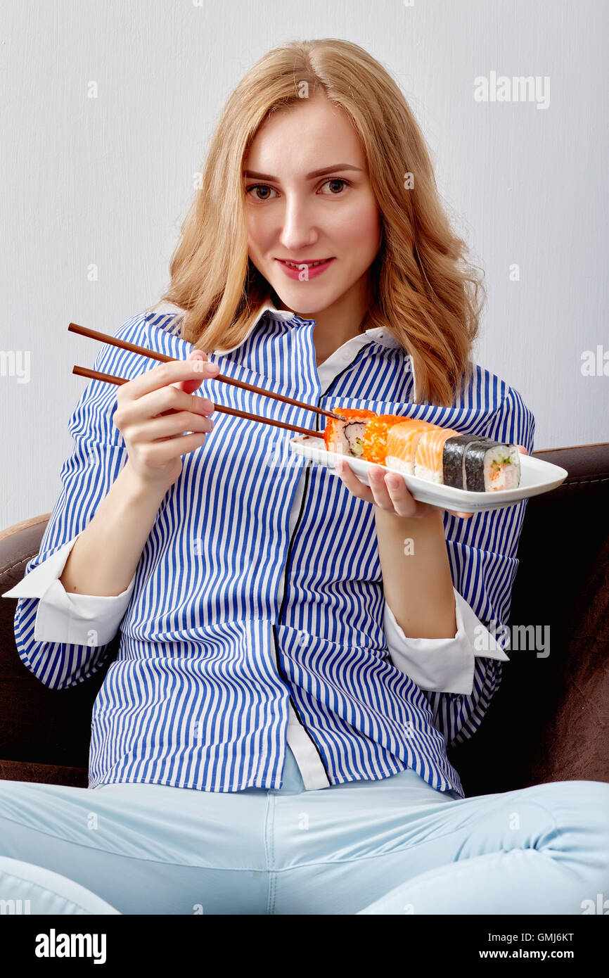 happy young woman with sushi looking at camera Stock Photo - Alamy