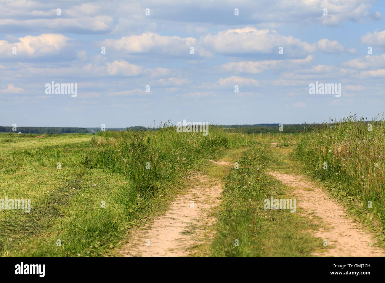 clouds over field Stock Photo - Alamy