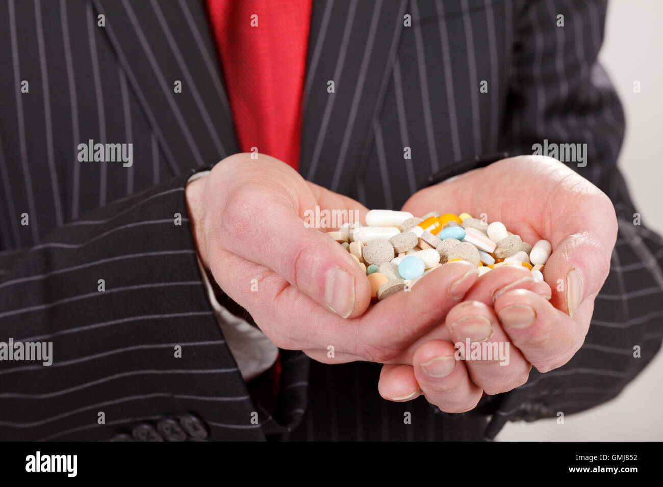 man holding pills Stock Photo - Alamy
