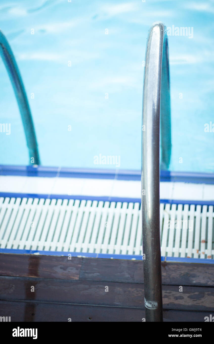 Hot summer by the outdoors swimming pool with wooden sundeck terrace ...