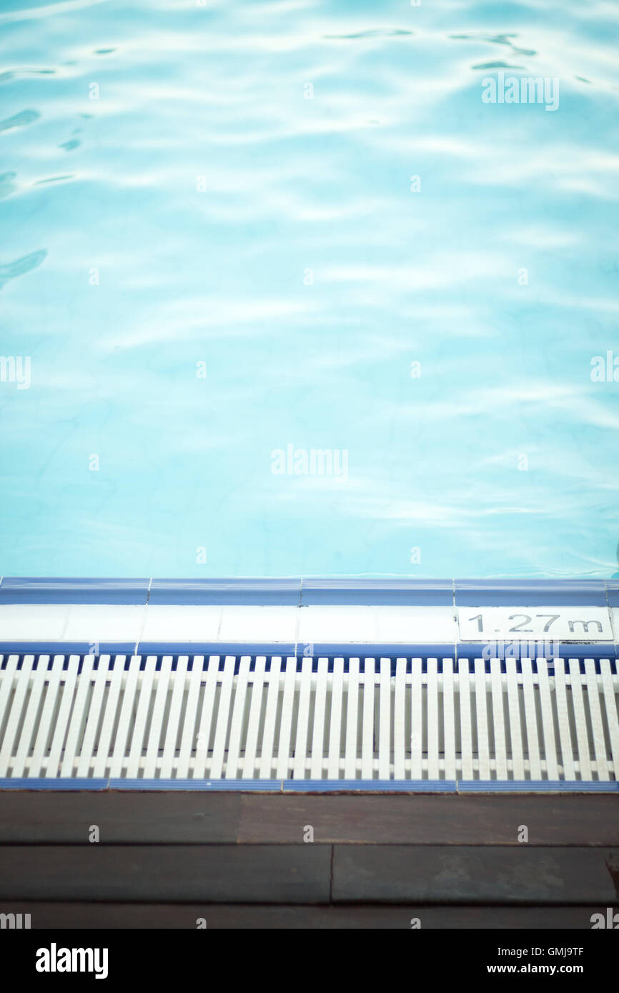 Hot summer by the outdoors swimming pool with wooden sundeck terrace ...