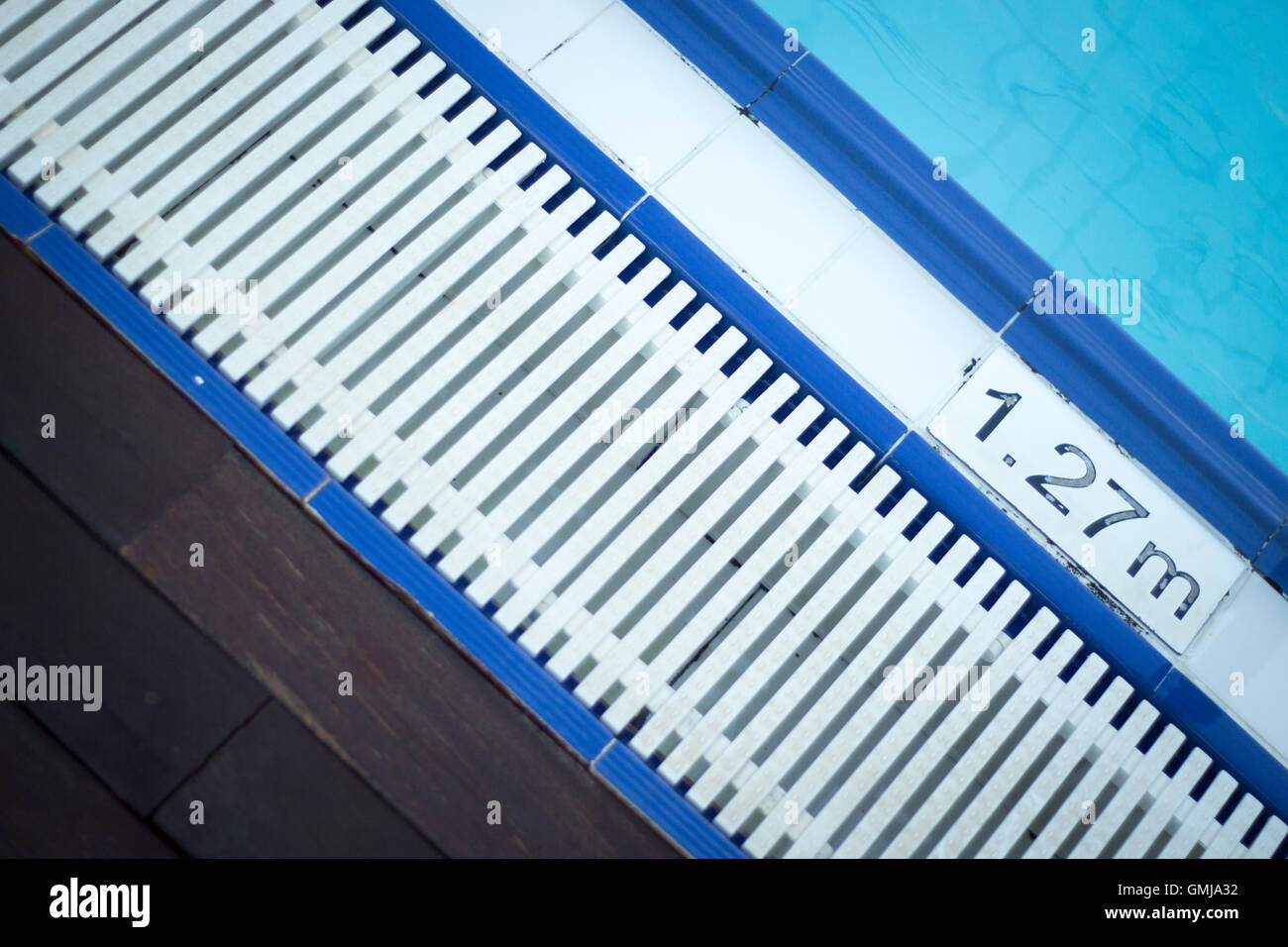 Hot summer by the outdoors swimming pool with wooden sundeck terrace ...