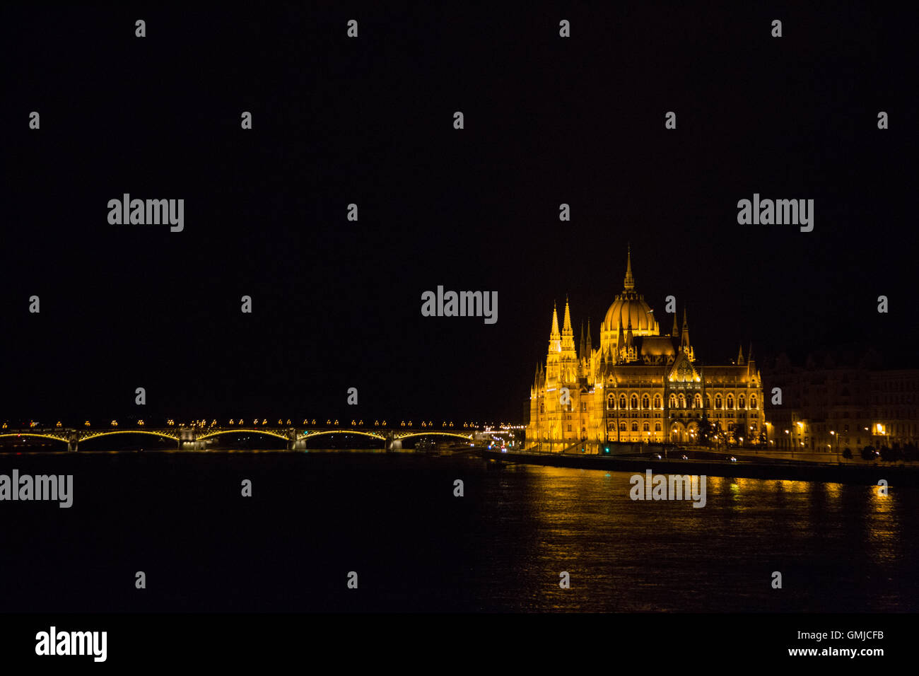 The Hungarian Parliament at night with the Margaret (Margit) Bridge in ...
