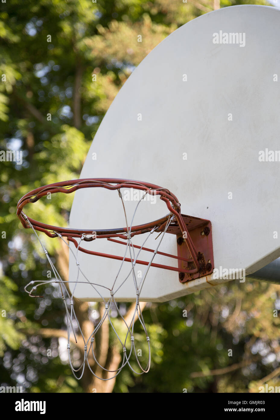 Basketball hoop on a green and sunny background Stock Photo - Alamy