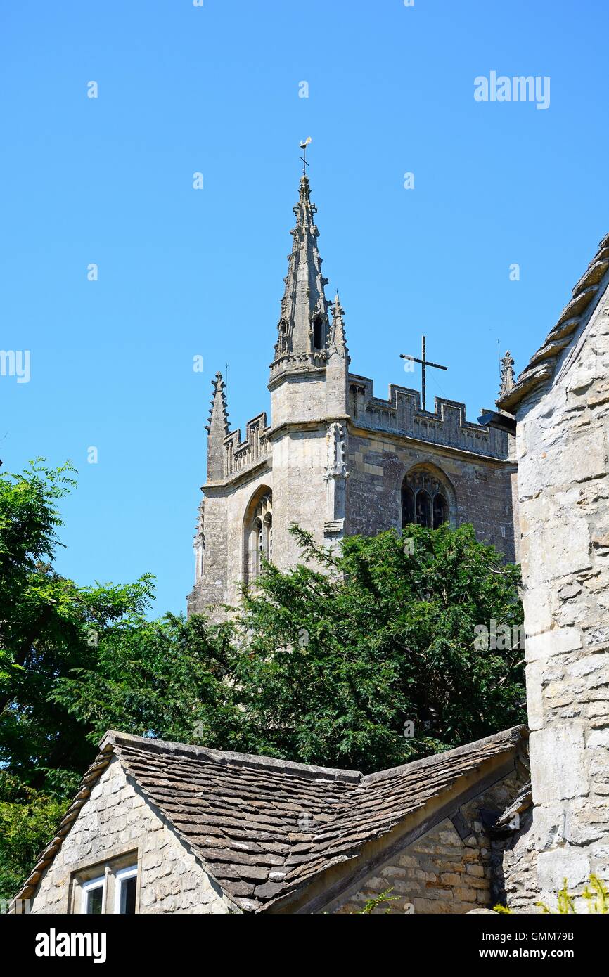 View of St Andrews church tower above a cottage roof, Castle Combe ...