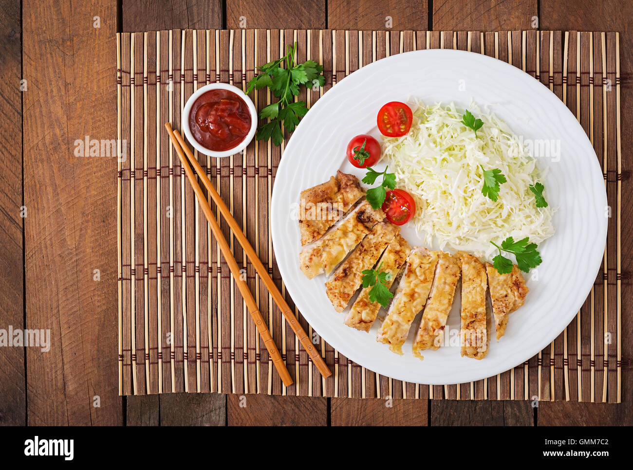 Fried pork cutlet with fresh cabbage salad and sauce. Top view Stock ...