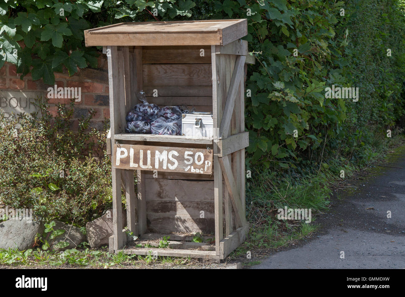 Farm Wrapped plums in weighed bags. and silver roadside wooden honesty ...