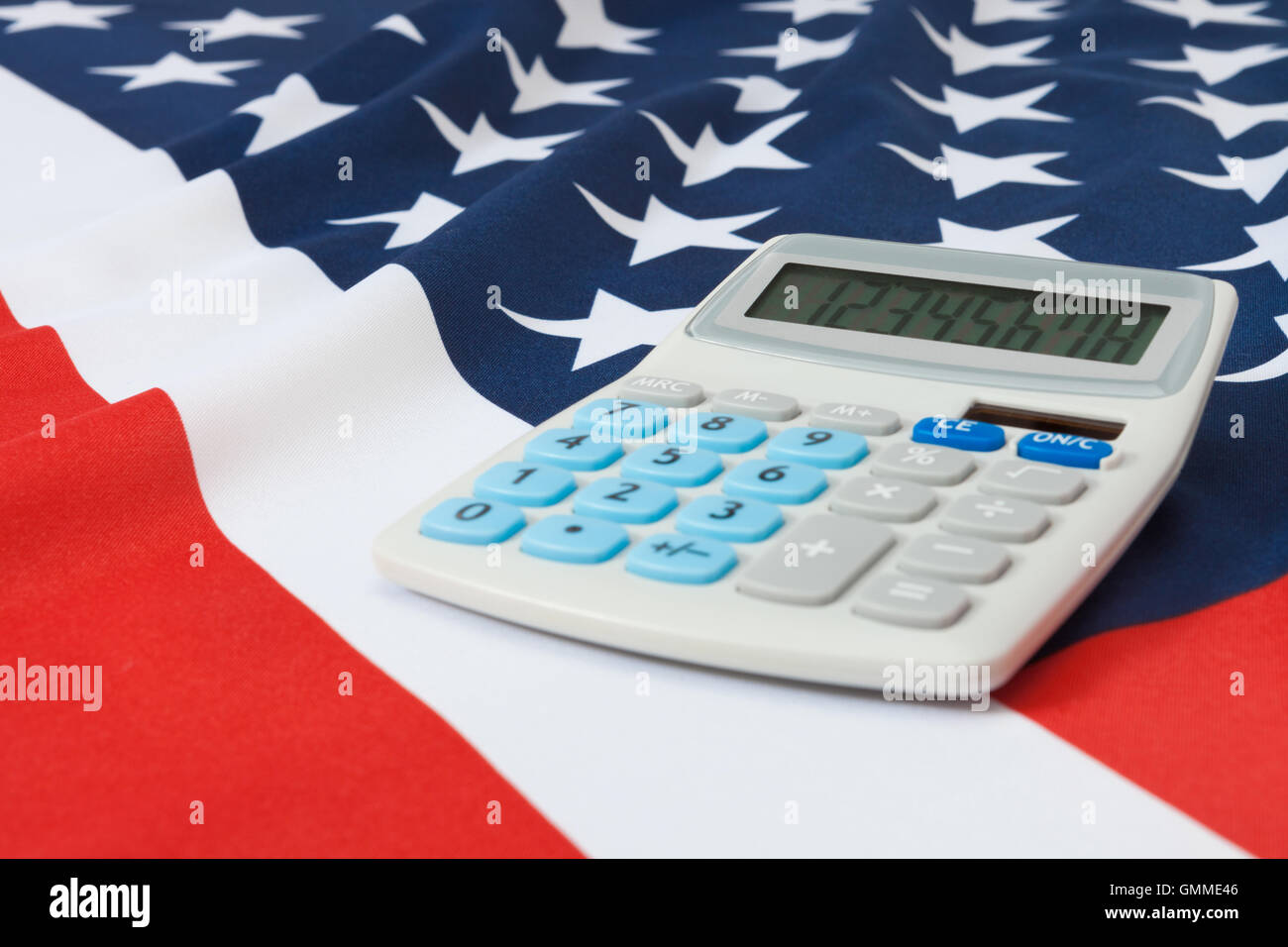 Part of studio shoot ruffled national flag with calculator over it ...