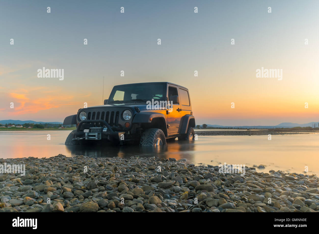 Jeep 4x4 against the sunset. Jeep got stuck in the mud Stock Photo - Alamy