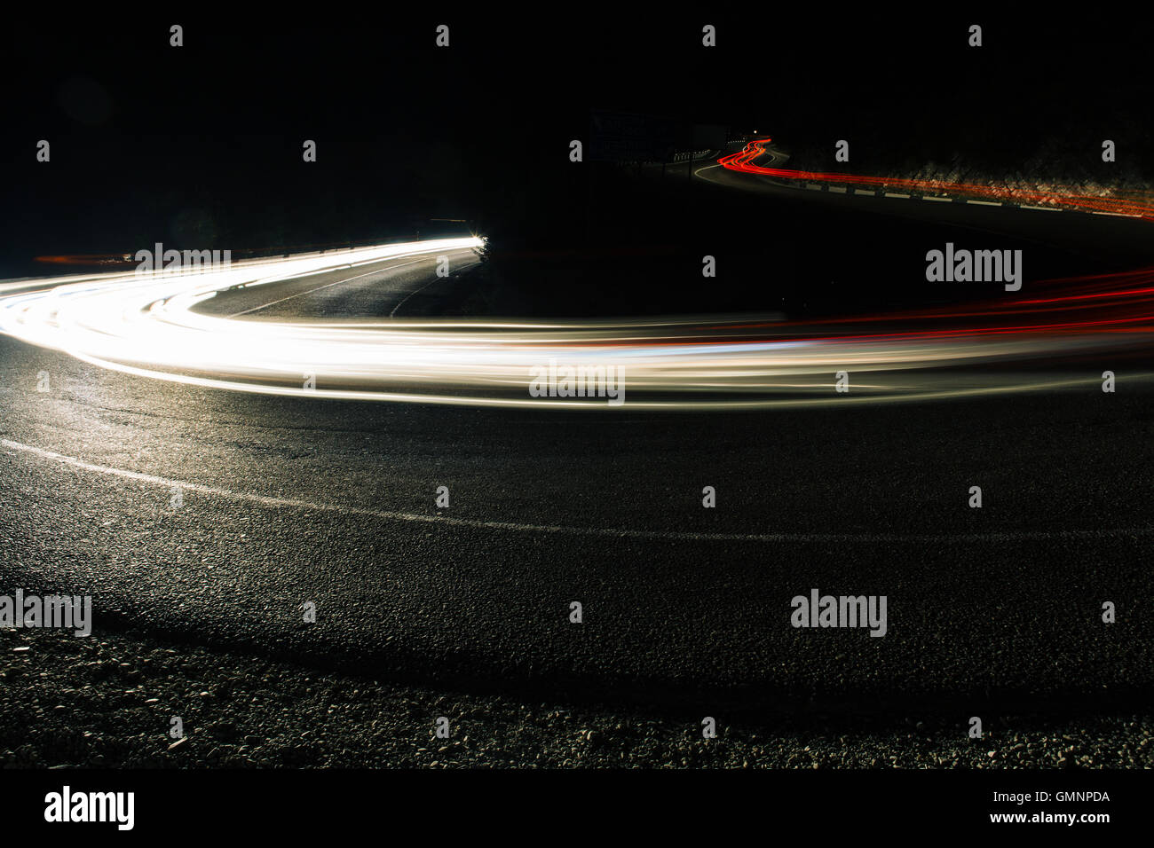 Bright car lines on night road Stock Photo - Alamy