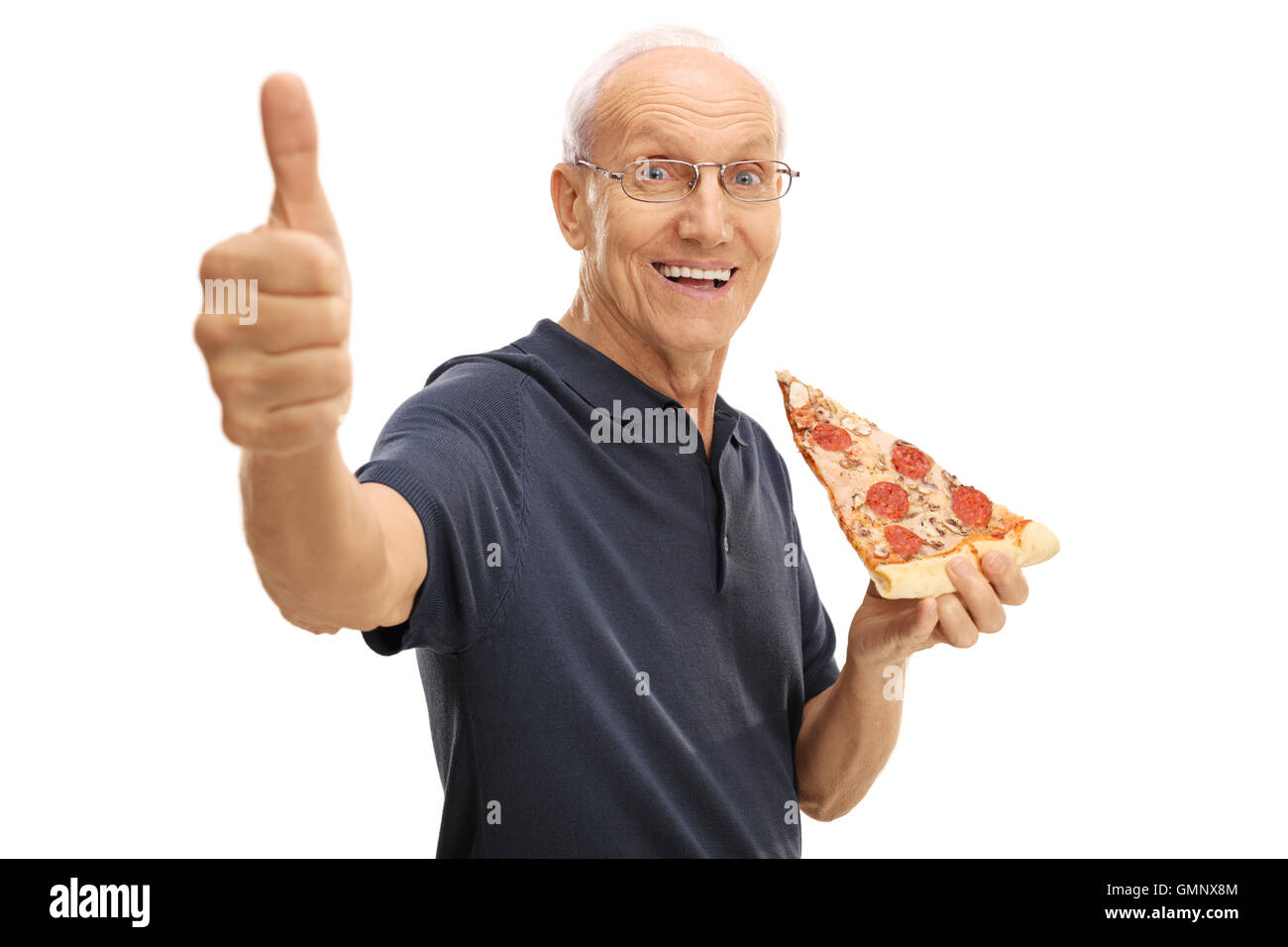 Elderly man eating a slice of pizza and giving a thumb up isolated on ...