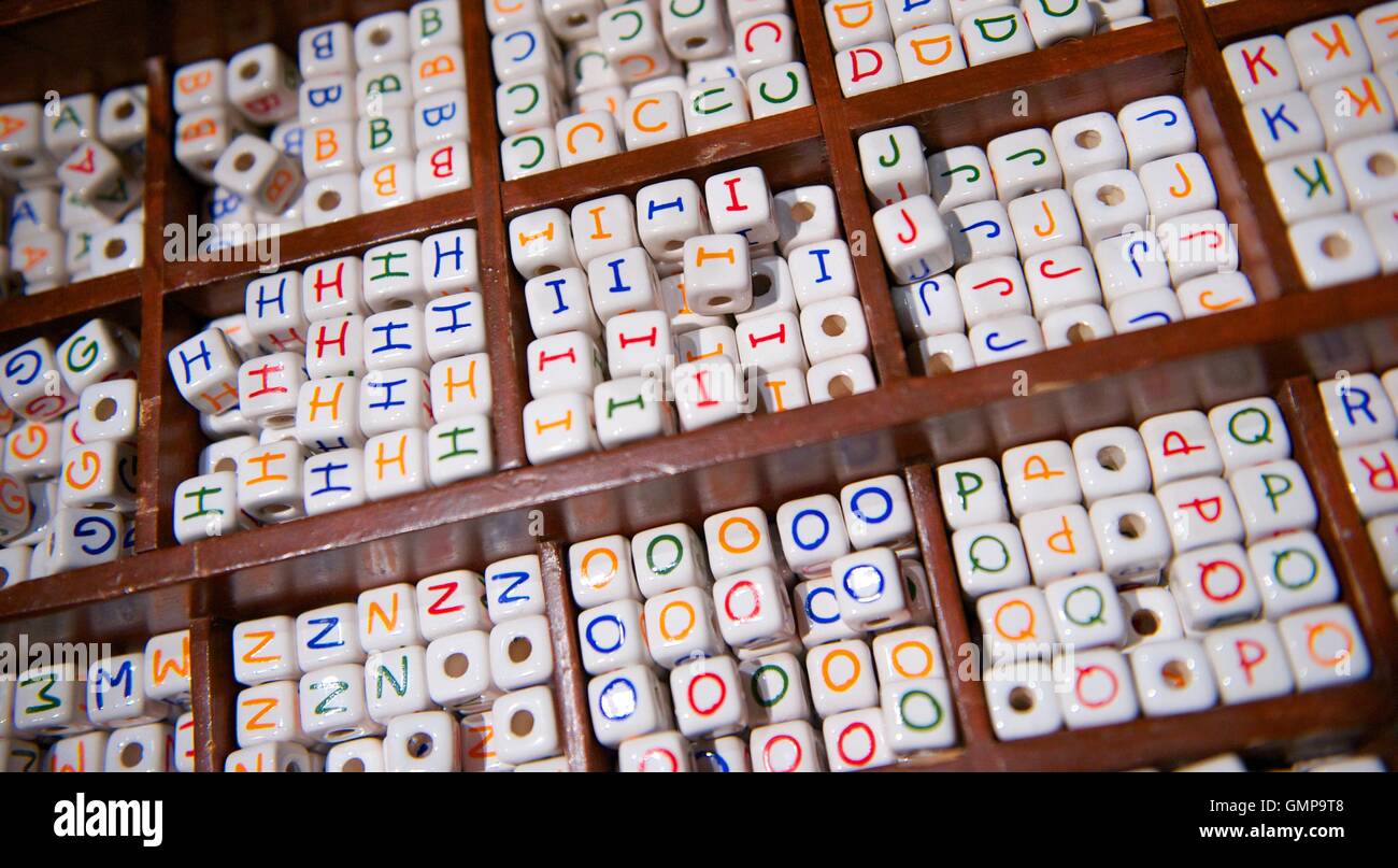 Wooden Tray of Ceramic Beads of the Alphabet Stock Photo - Alamy