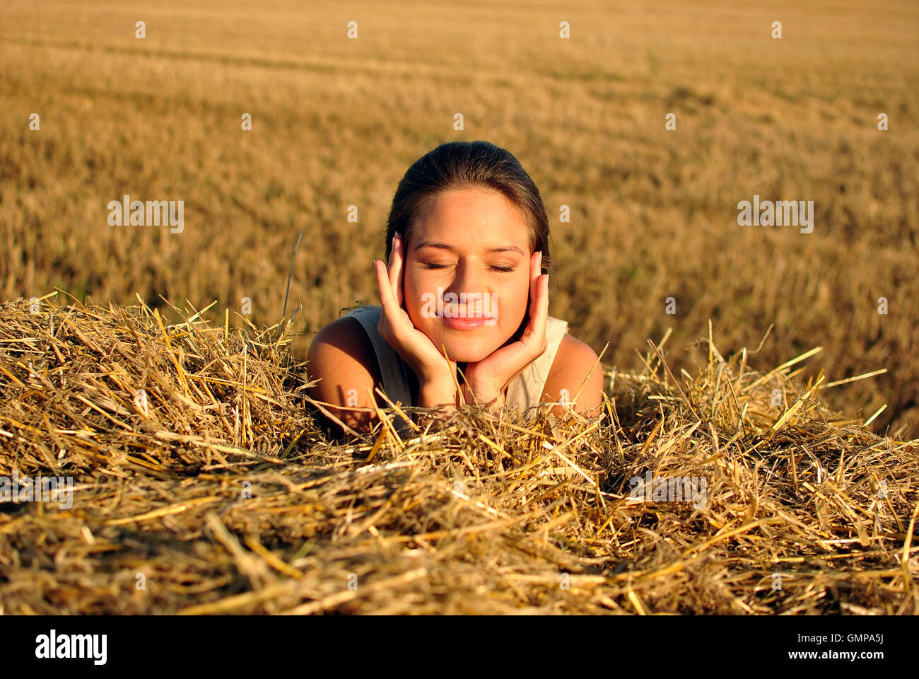 girl in traditional Russian costume resting on a haystack Stock Photo ...