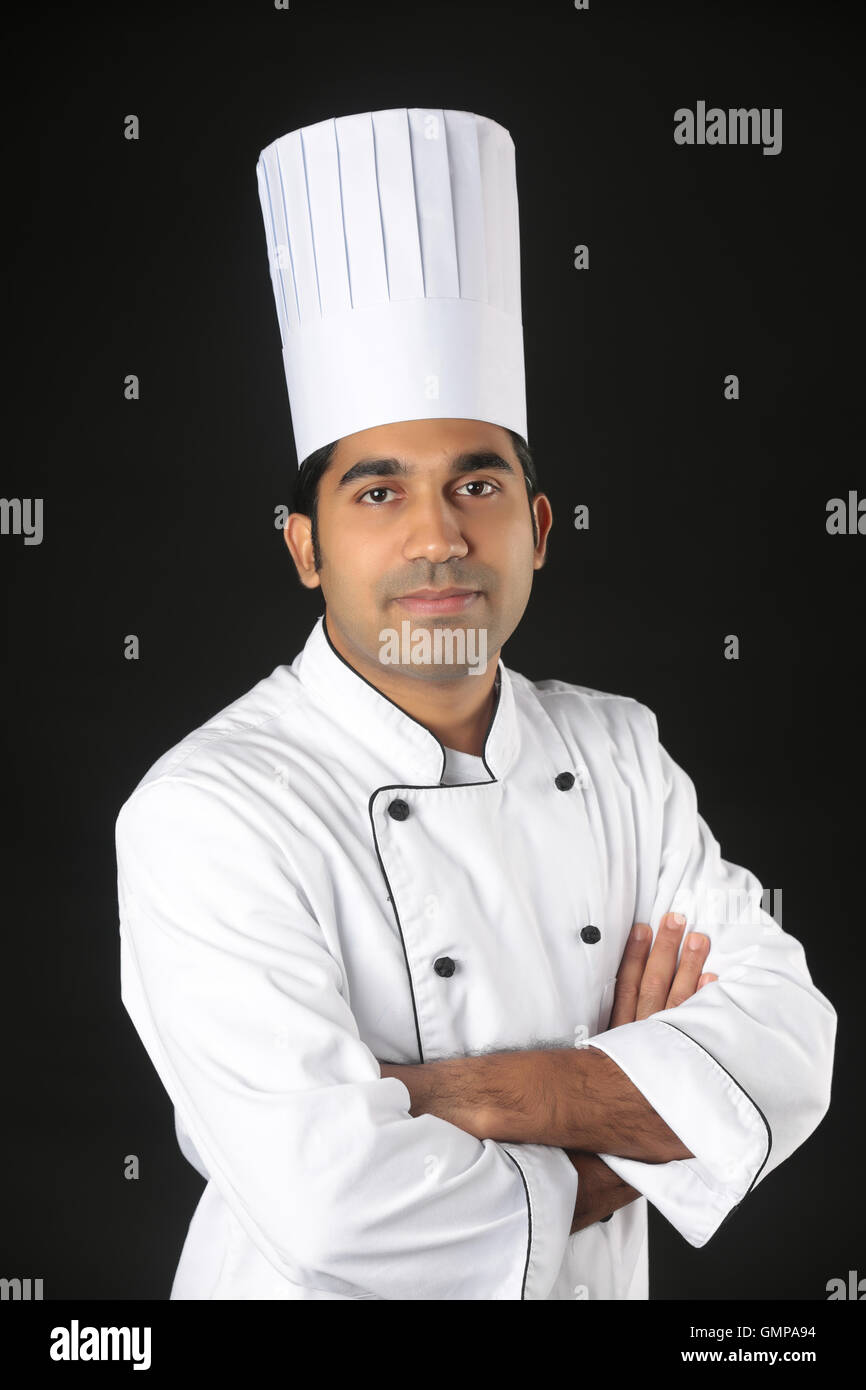 cooking, profession and people concept - happy male indian chef in ...