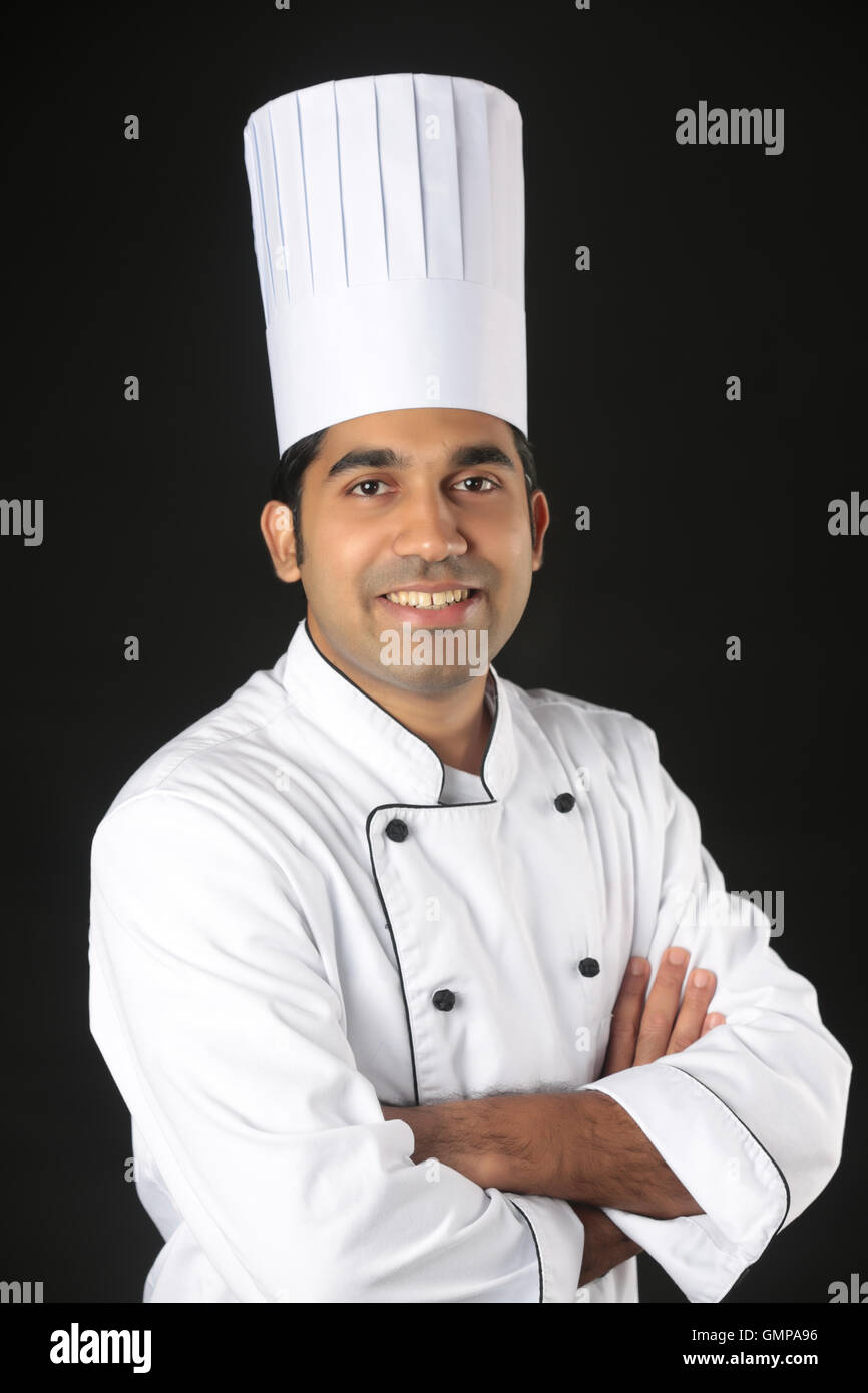 cooking, profession and people concept - happy male indian chef in ...