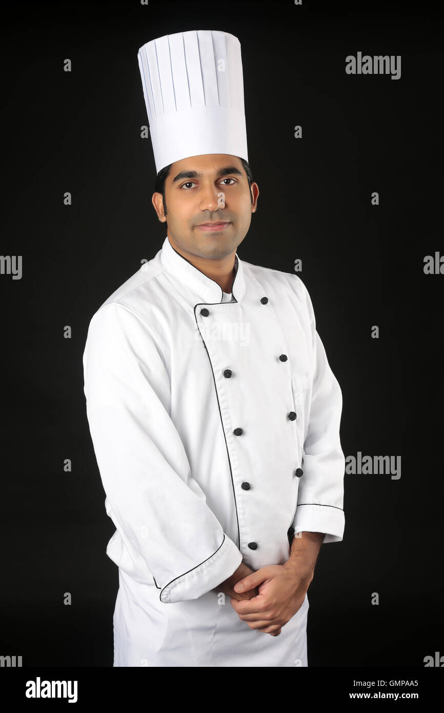 cooking, profession and people concept - happy male indian chef in ...