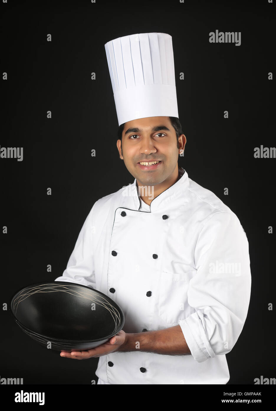 cooking, profession and people concept - happy male indian chef in ...