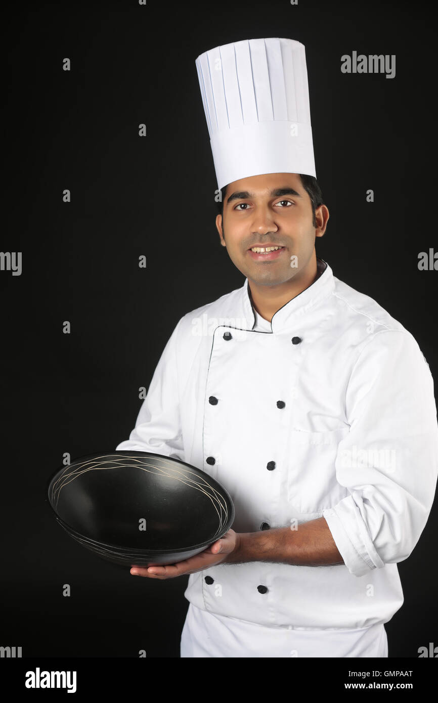 cooking, profession and people concept - happy male indian chef in ...
