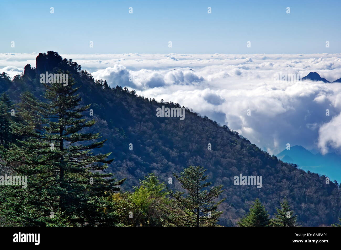 Mountain peaks. Tree. Clouds Stock Photo - Alamy