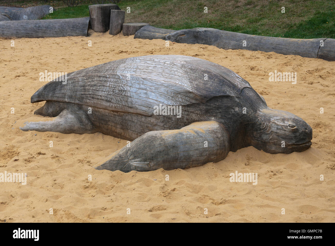 Wooden sea turtle in the sandbox Stock Photo - Alamy