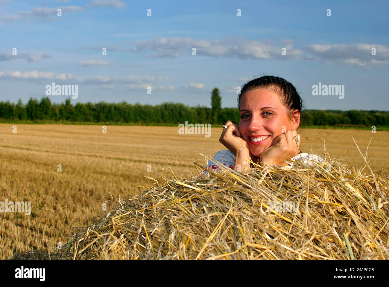 girl in traditional Russian costume lying on a haystack and smiling ...