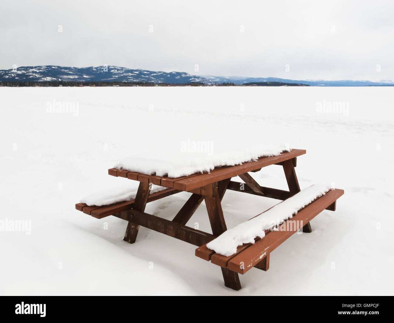 Camp table benches and snowy frozen lake landscape Stock Photo - Alamy