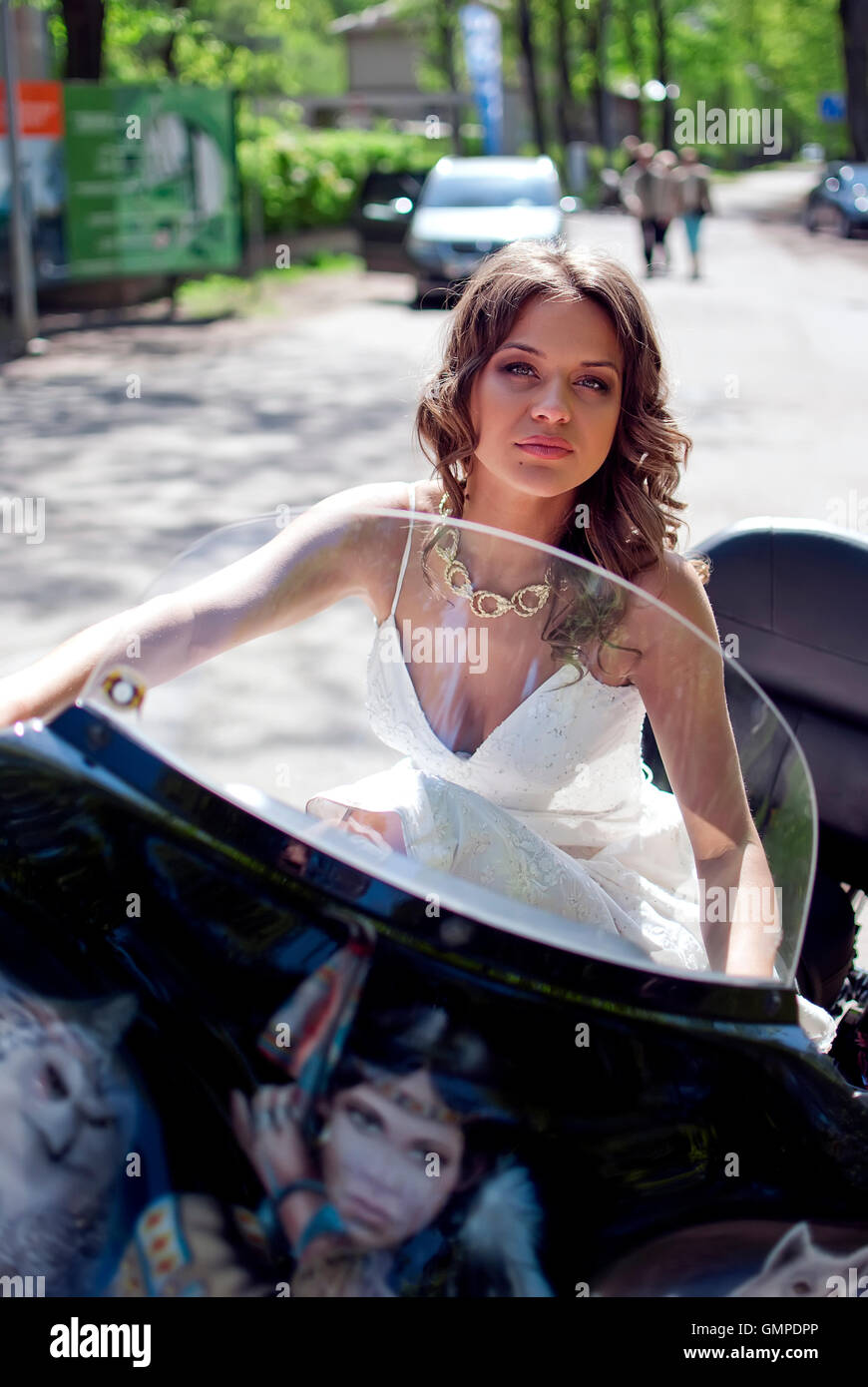 beautiful young bride sitting on a motorcycle Stock Photo - Alamy