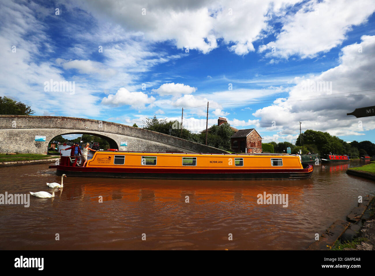 A canal boat passes along the Shropshire Union Canal in Middlewich ...