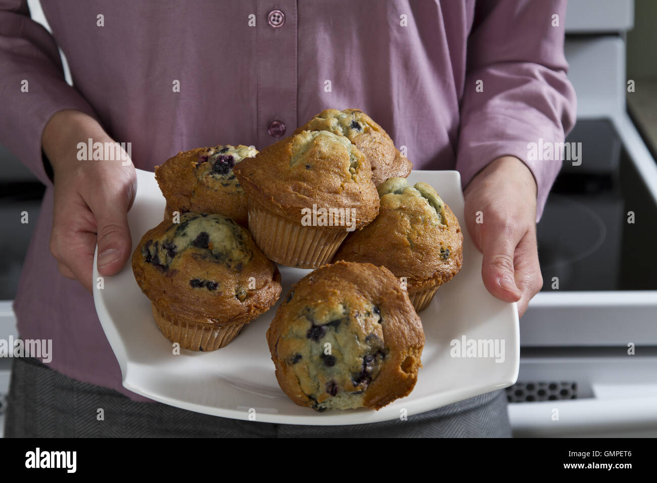 Holding the muffins Stock Photo - Alamy