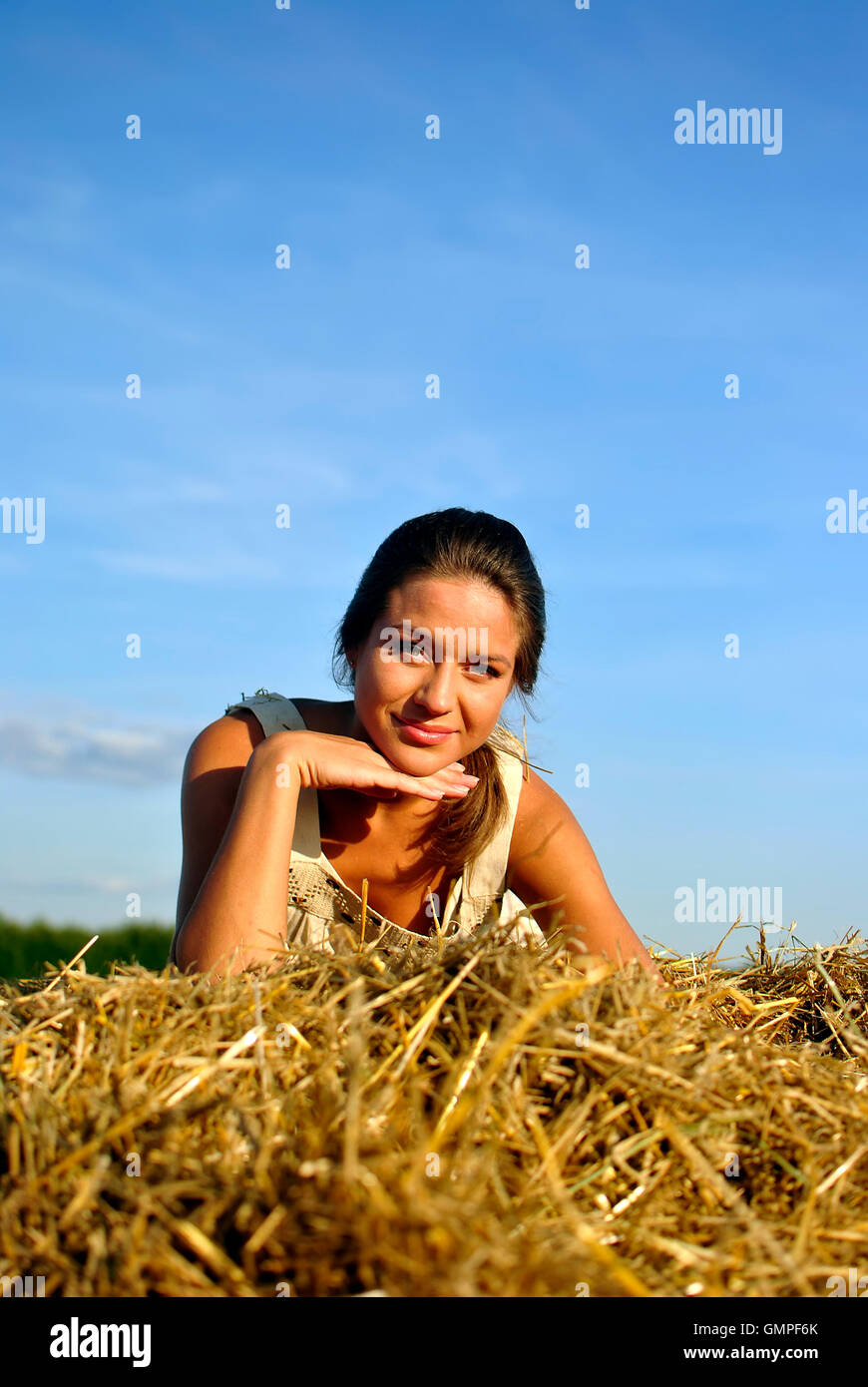 girl in traditional Russian costume resting on a haystack Stock Photo ...