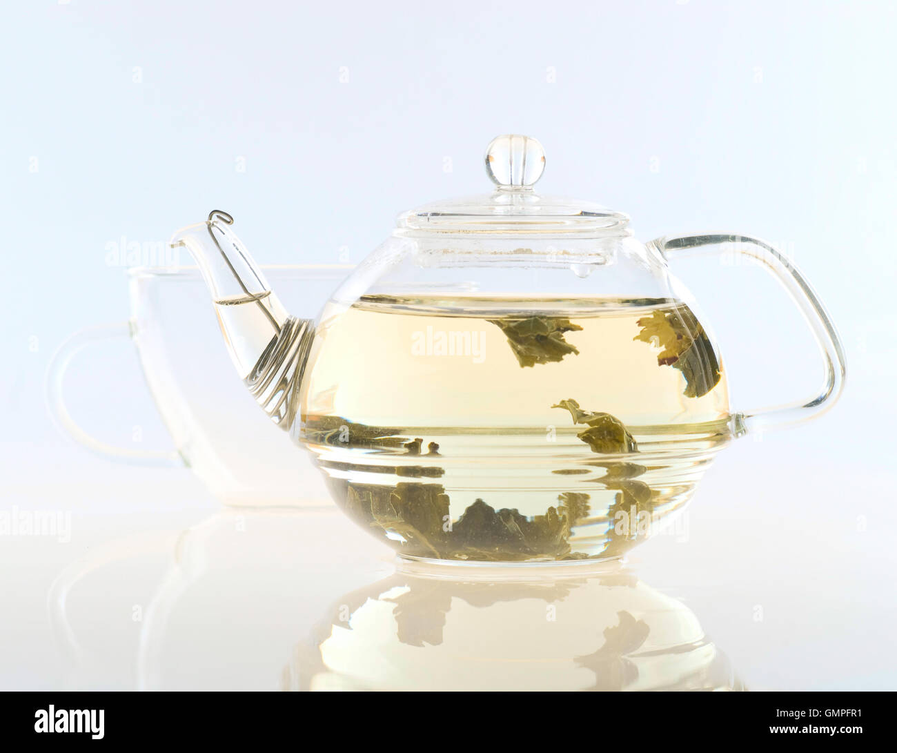Glass tea pot with tea and cup Stock Photo - Alamy