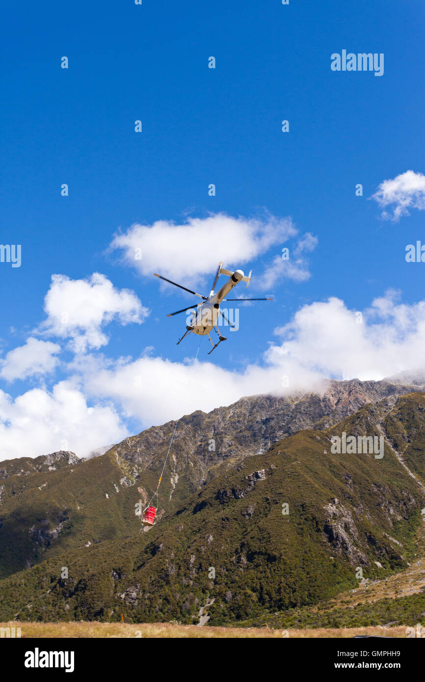 Transport helicopter fly over mountain wilderness Stock Photo - Alamy