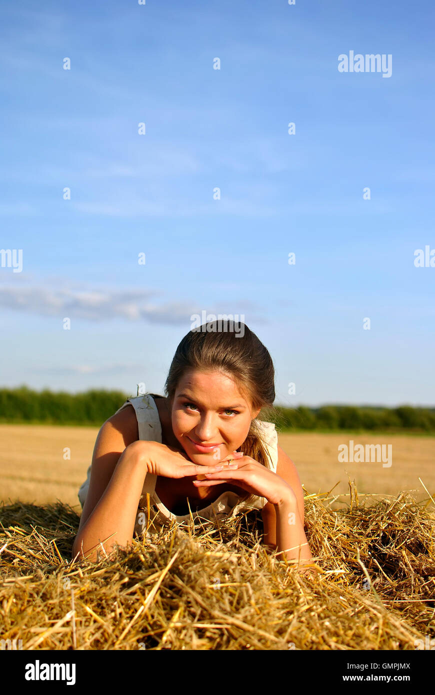 girl in traditional Russian costume resting on a haystack Stock Photo ...