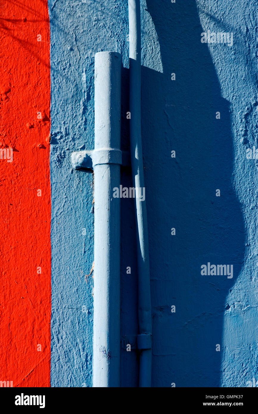 blue colored pipe and red wall Stock Photo - Alamy
