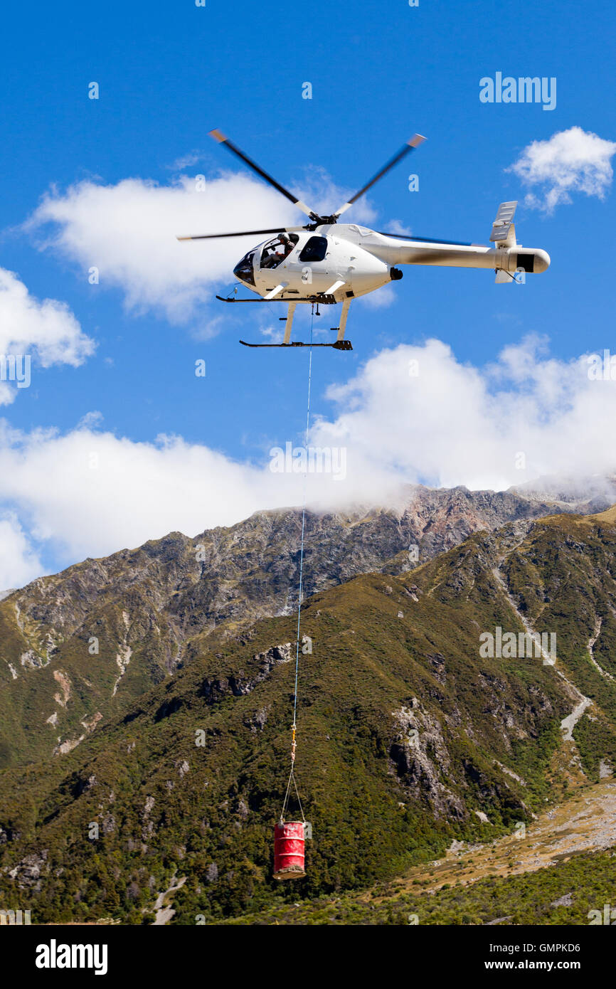 Transport helicopter fly over mountain wilderness Stock Photo - Alamy