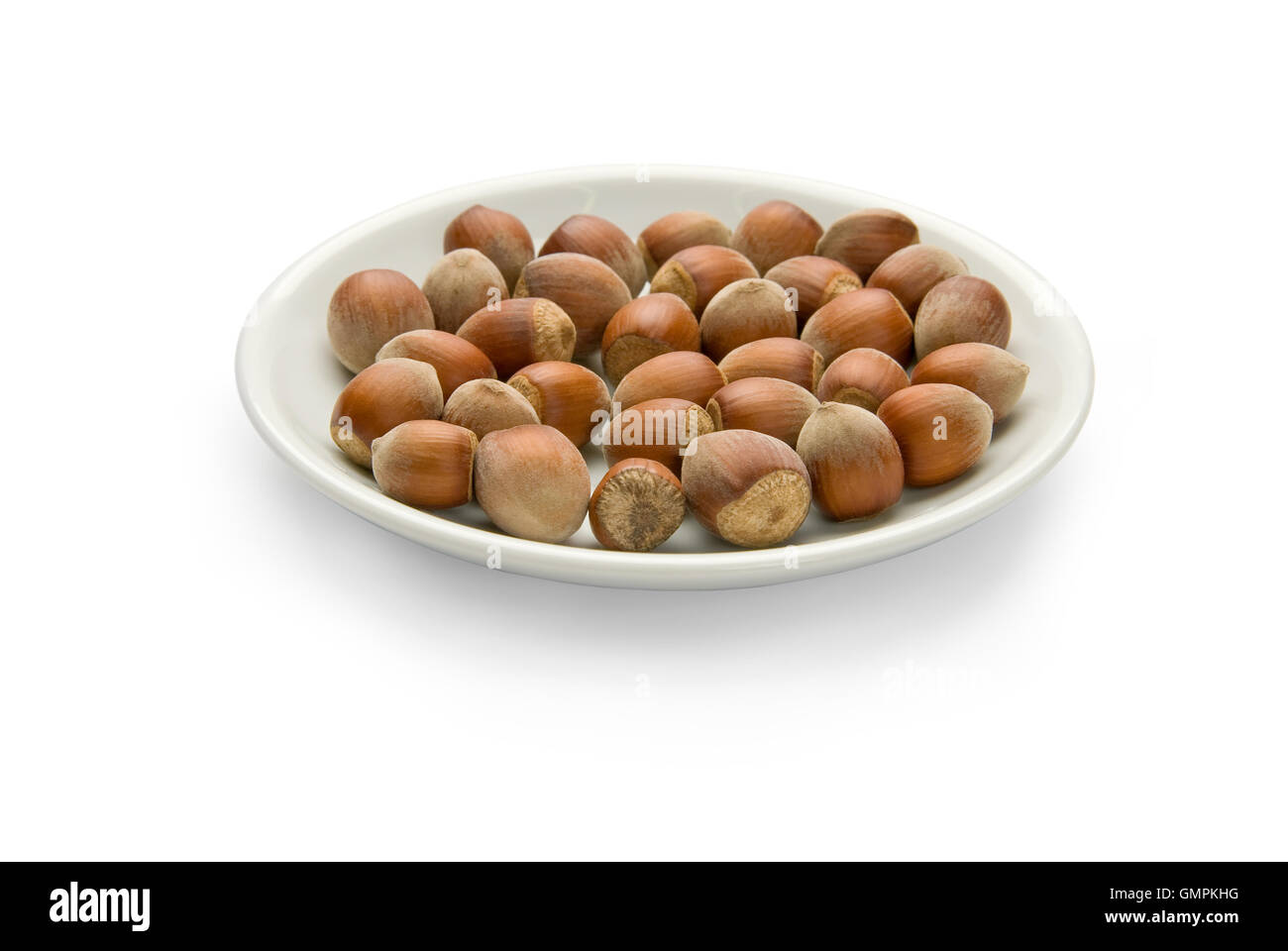 Nuts in a plate, isolated on white background Stock Photo - Alamy